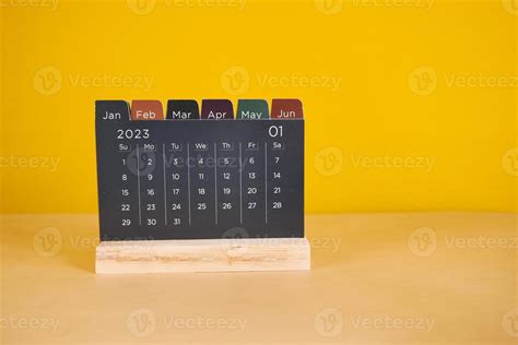 A Calendar On Table Against Yellow Background Stock Photo At Vecteezy