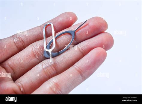 Close Up Of The Sim Ejector Sim Card Opening Tool Inside A Cell Phone Stock Photo Alamy
