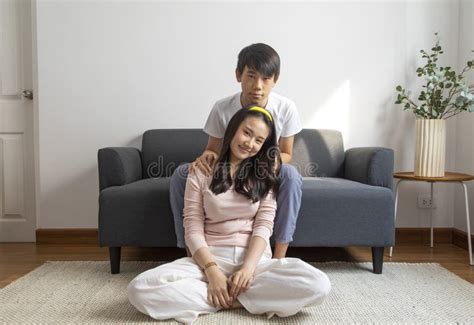 Asian Brother And Sister Hugging With Care And Love Stock Image