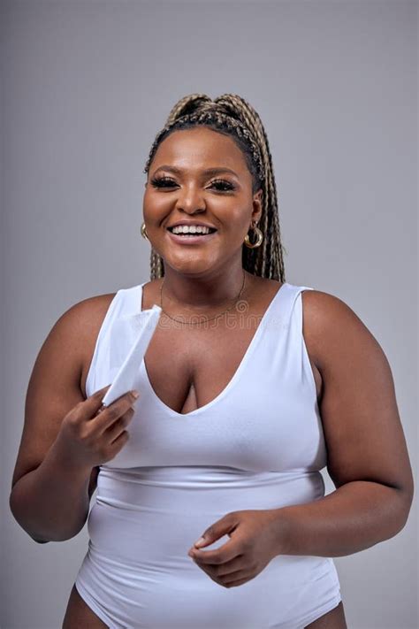 Young Chubby Black Lady With Makeup Wearing White Fluffy Coat And Hat
