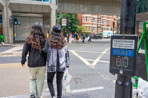 People Crossing The Road At The Pedestrian Crossing With Traffic Control Using Manually