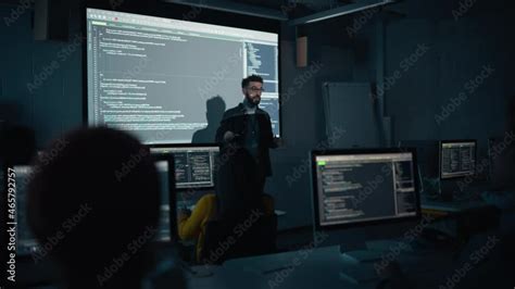 Teacher Giving Computer Science Lecture To Diverse Multiethnic Group Of Female And Male Babes