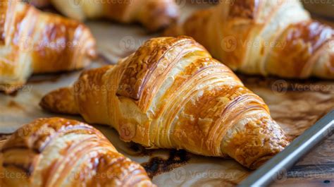 Golden Flaky Croissants Fresh Out Of The Oven Are Placed On A Lined