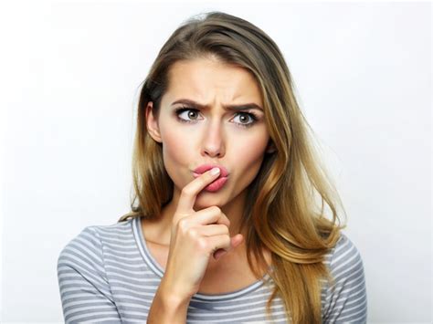 A Young Women Making A Skeptical Expression With Her Tongue Out And