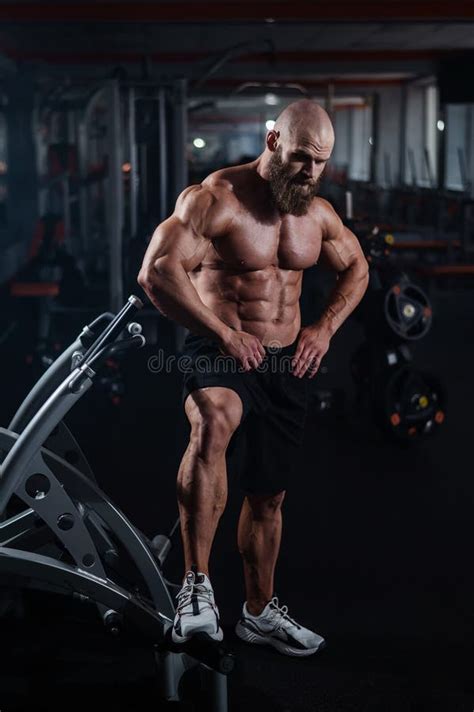 Muscular Bald Man Posing In Shorts Bodybuilder Showing Off His Shape