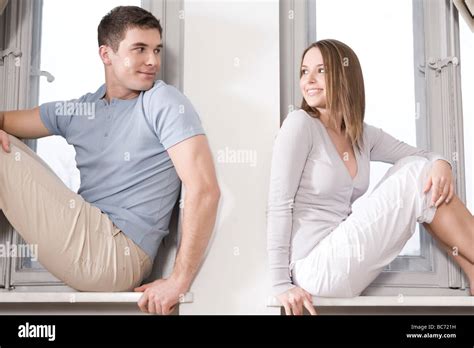 Couple Sitting Next To Window Stock Photo Alamy