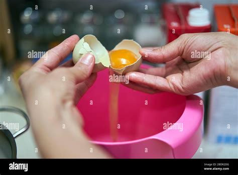 Woman S Hands Separating Egg Yolk From Whites Stock Photo Alamy