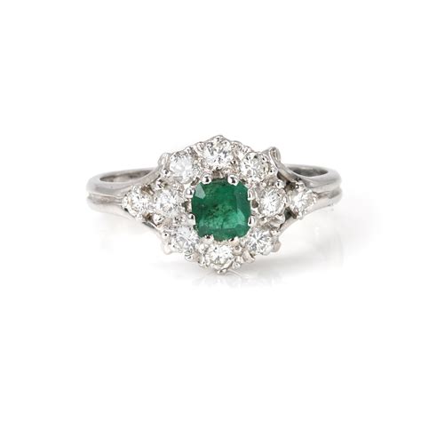 At Auction An 18ct White Gold Emerald And Diamond Cluster Ring
