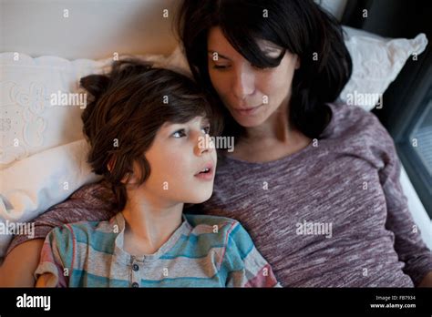 Mother And Son Lying On Bed Stock Photo Alamy