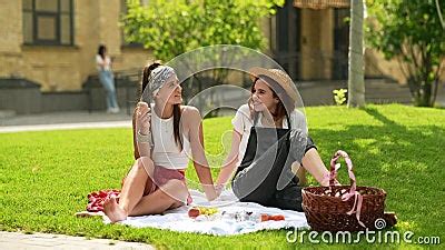 Two Women Having Picnic Together Sitting On The Plaid On The Park Lawn Stock Video Video Of