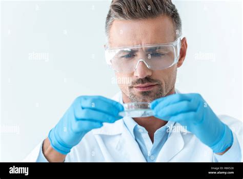 Portrait Of Handsome Scientist In Protective Glasses Looking At Reagent