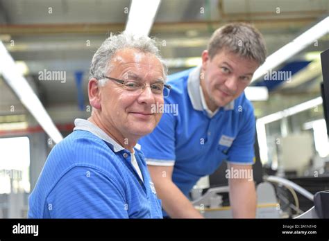 Engineer Working On A Machine For Assembly And Production Of Semiconductor Boards In An