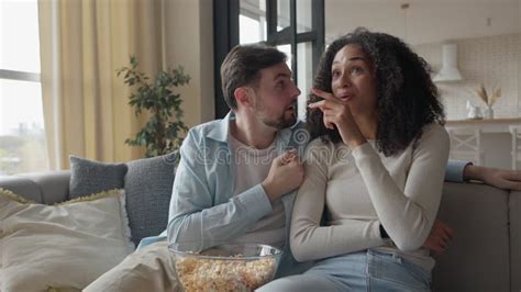 Surprised Couple Watching Movie Reacting With Shock While Eating
