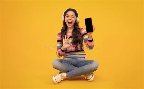 Portrait Of Cute Teenage Girl Using Mobile Phone Chatting On Web