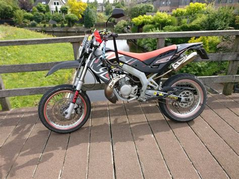 50cc Dirt Bike Parked on Wooden Deck