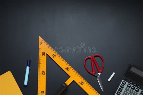 Triangle Ruler Scissors Chalk Calculator Marker And Notebook On