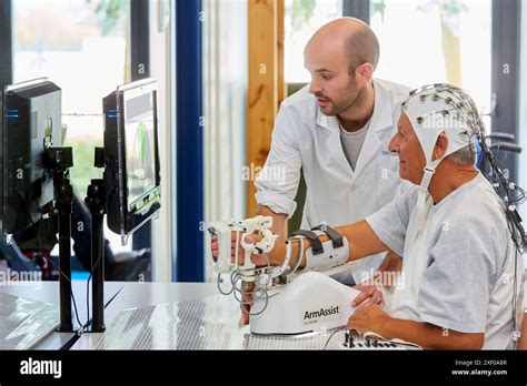 Investigator And Patient With Assistive Robot For Upper Limb