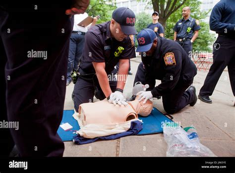 Fire And Ems Technicians Emt Paramedic Performing Cpr On Cpr Manikin