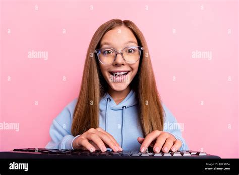 Photo Of Cheerful Astonished Girl Toothy Smile Keyboard Write Typing Isolated On Pink Color