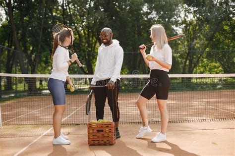 Two Women And Black Race Trainer At Tennis Court Stock Image Image Of