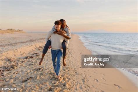 Romantic Couple Walking Winter Beach Photos And Premium High Res