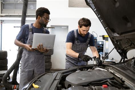 Two Mechanics Working on Car Engine with Laptop in Garage Stock Image - Image of labor, shop ...