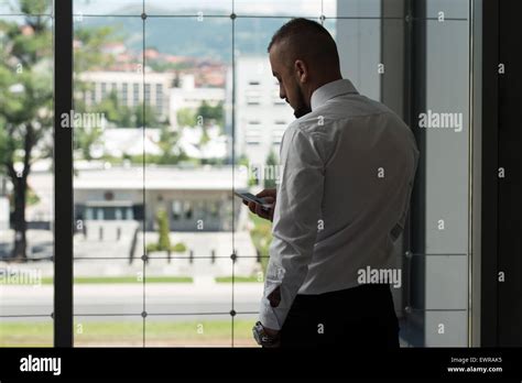 Business Man Reading Text Message On A Mobile In A Modern Office Stock Photo Alamy
