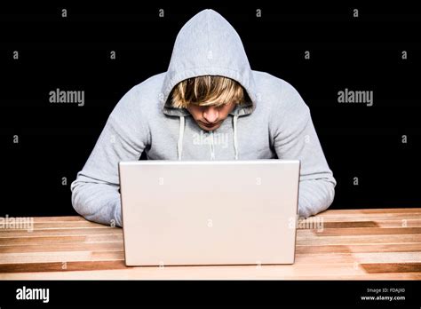 Man In Hood Jacket Hacking A Laptop Stock Photo Alamy