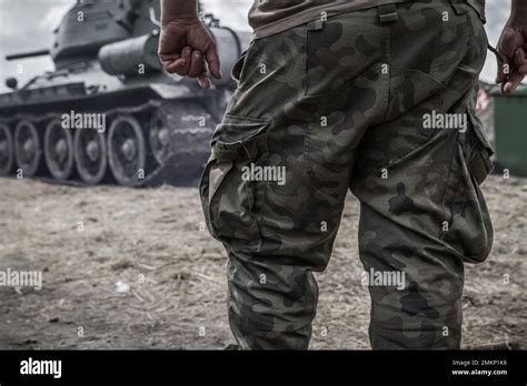 Soldier Legs On A Battlefield Wearing Woodland Camo Military Pants