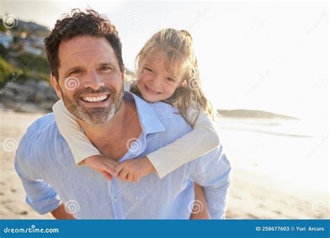 Portrait Of Smiling Caucasian Father Carrying Little Daughter On His