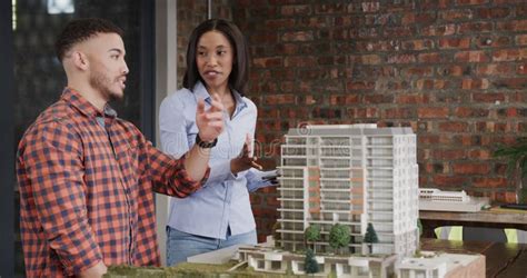 Diverse Male And Female Architect Discussing Architectural Model Slow Motion Stock Video
