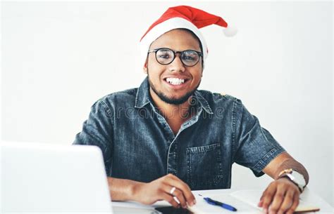 Christmas Laptop And Portrait Of Man In Hat At Desk Of Web Development Office For Holiday Shift