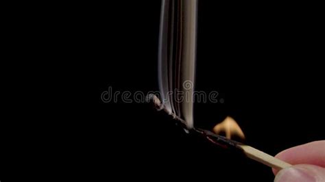 A Lighted Match Burns With Smoke On A Black Background Concept Of Slow