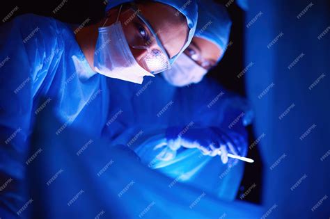 Premium Photo Doctors Team In Surgery In A Dark Background