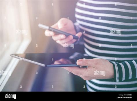 Smartphone And Tablet Data Synchronization Woman Syncing Files And Documents On Personal