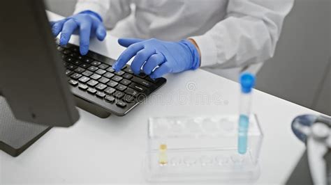 Caucasian Scientist Woman In Lab Typing On Keyboard With Experiment Sample And Stethoscope
