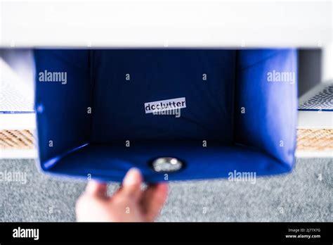 Hand Grabbing Storage Cube With Declutter Label Inside Of It With