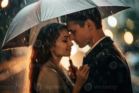 A Close Up Shot Of A Couple Embracing Under An Umbrella In The Rain