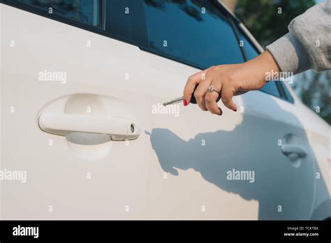 Woman With Car Key Opening Car Door Woman S Hand Unlock A Door On A Car Sunlight