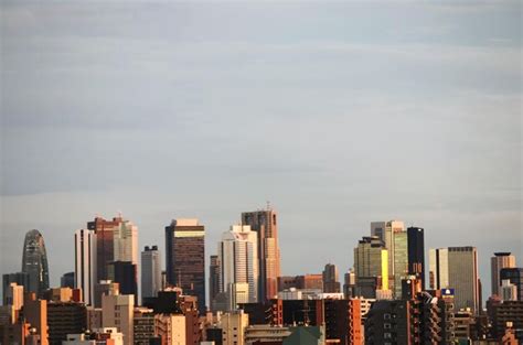 Premium Photo City Buildings Against Cloudy Sky