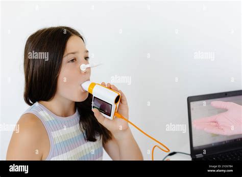 Girl Testing Breathing Function By Spirometry In Doctors Office Diagnosis Of Respiratory