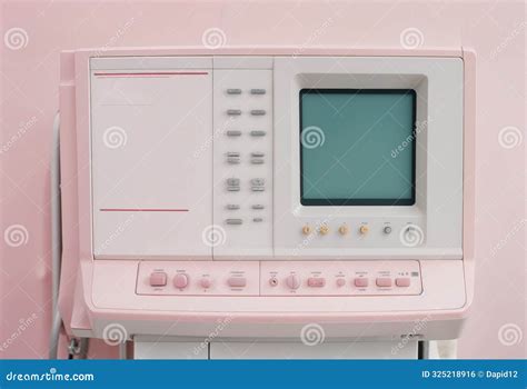 A Pink Mammogram Medical Machine With A Monitor On It Stock