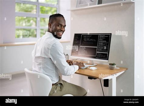 African American Coder Using Computer At Desk Web Developer Stock