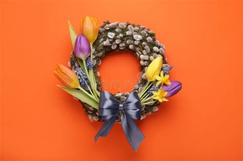 Willow Wreath With Different Beautiful Flowers And Grey Bow On Orange