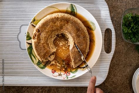 Female Hand Cutting On A Plate Flan Creme Caramel Made With Eggs Coconut Milk And Coconut