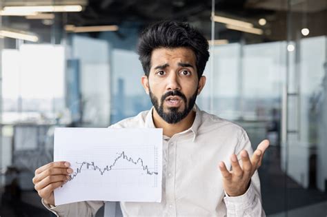 Man Showcases Graph Using Gestures And Handwritten Font On Paper Stock