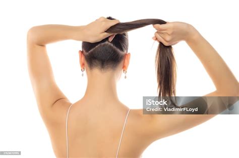 Rear View Of A Young Modern Woman With Partially Shaved Head And