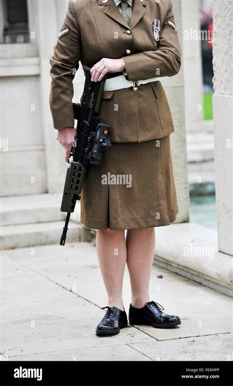 Female Army Soldier In British Armed Forces Carrying A Gun Weapon Stock