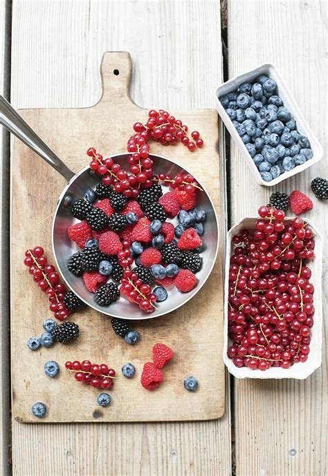 Various Berries In Cardboard Planets And A Frying Pan Photograph By Sabine Steffens Fine Art
