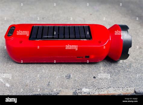 Dual Charging Red Flashlight With Small Solar Panel On The Topside